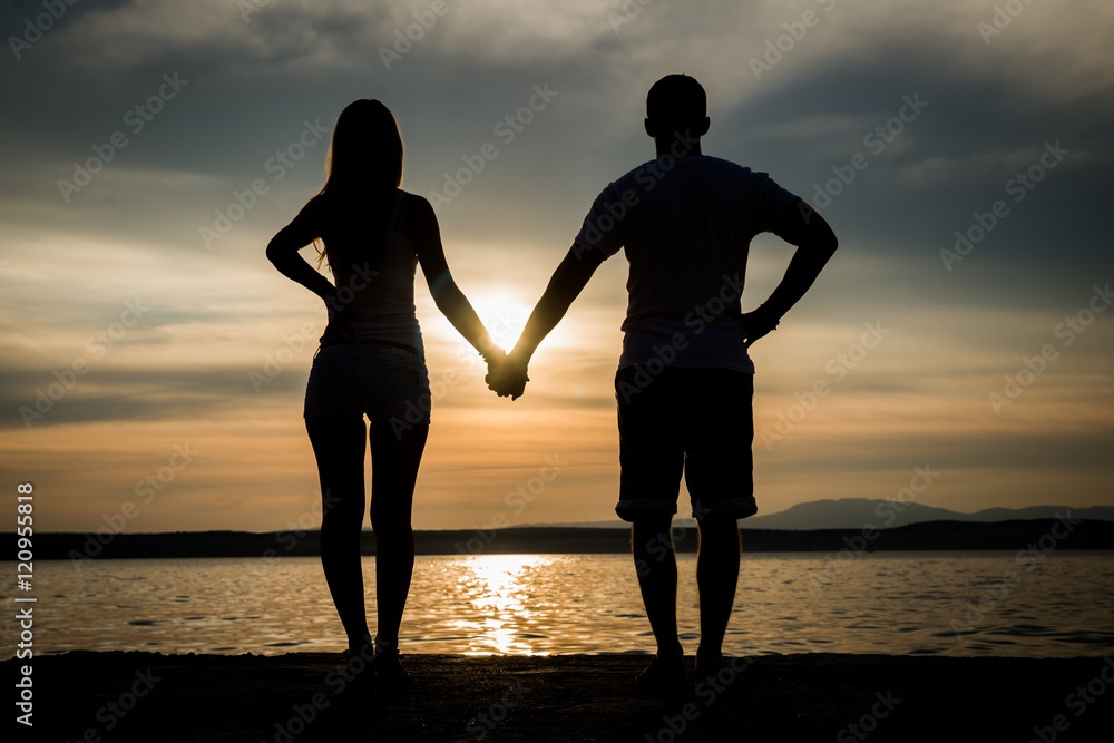 Young couple in love, silhouettes. Attractive man and woman enjoying ...