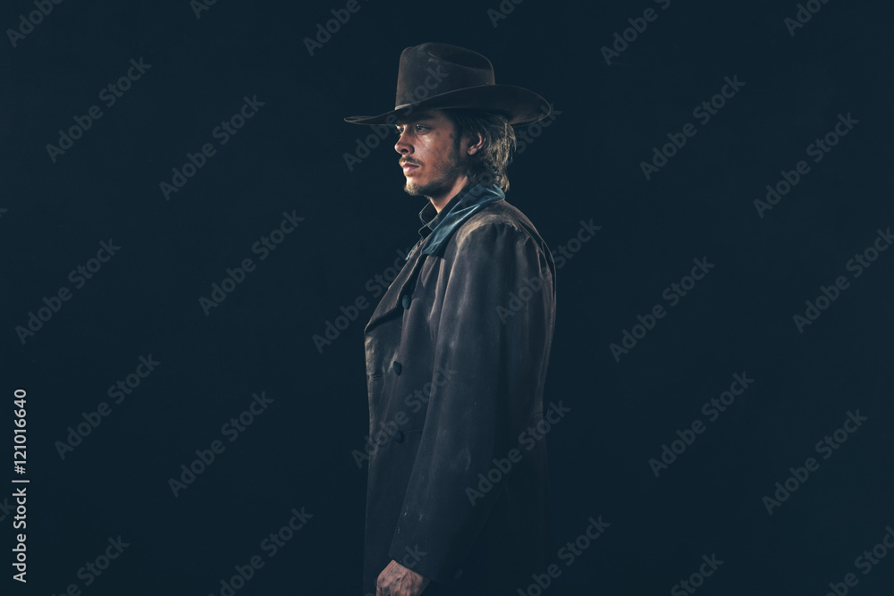 Side view of vintage 1900 cowboy. Young man. Studio shot against Stock ...