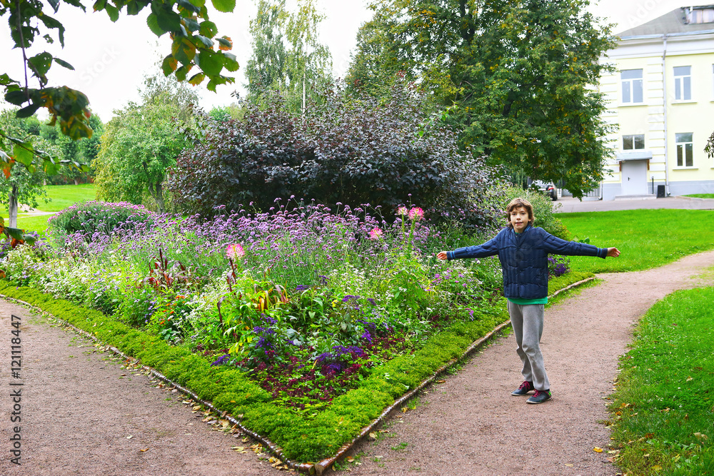 boy in landscape with flowers trees and building Stock Photo | Adobe Stock