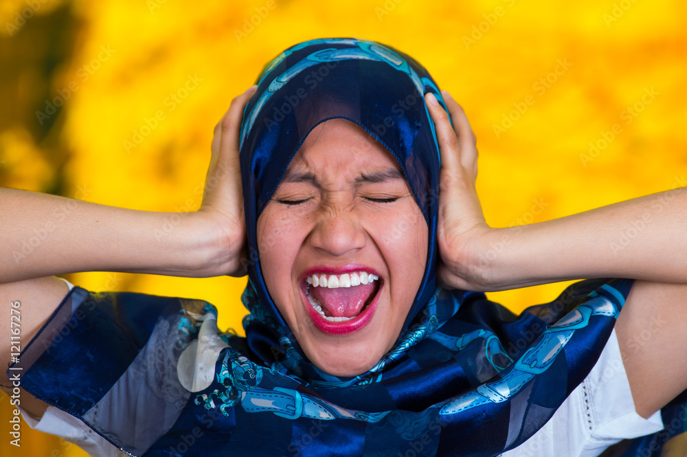 Beautiful young muslim woman wearing blue colored hijab, facing camera ...