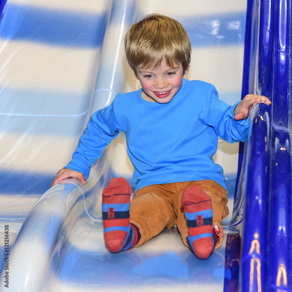 kleiner Junge beim Rutschen Stock Photo | Adobe Stock