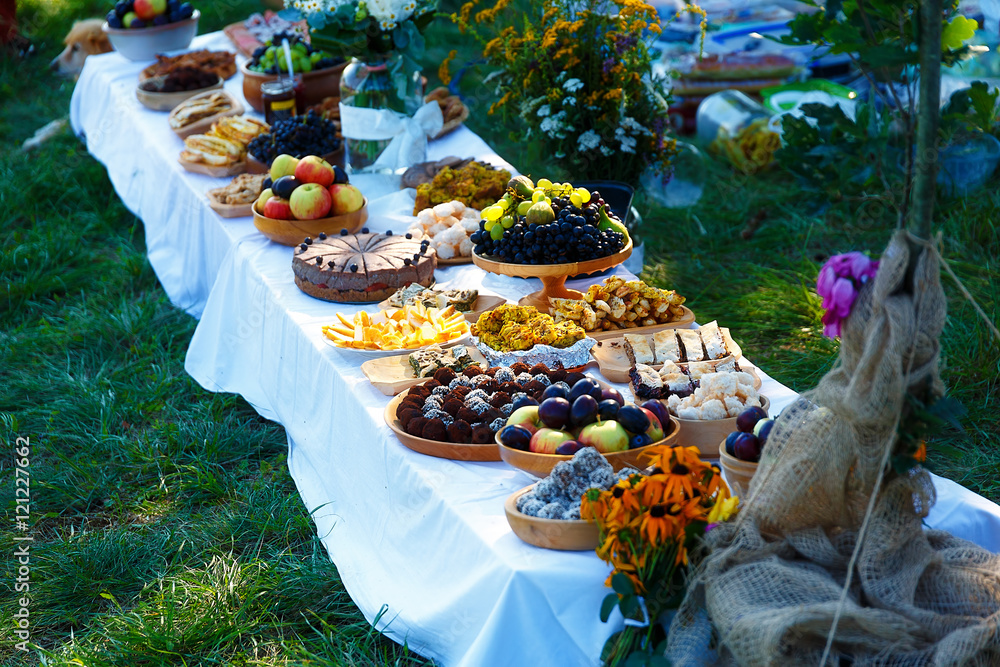 Beautiful wedding feast in nature, abundance of meals on a table. Stock ...