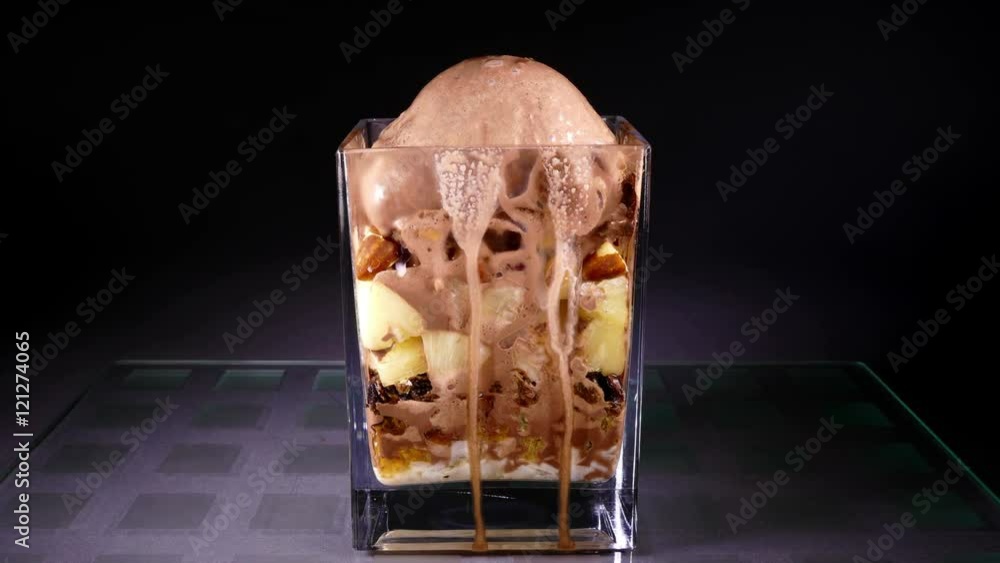 Vidéo Stock Timelapse of ice cream, melting over mixed fruit and nuts ...