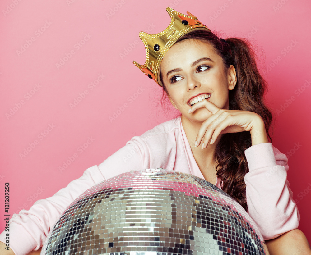 young cute disco girl on pink background with disco ball and crown ...