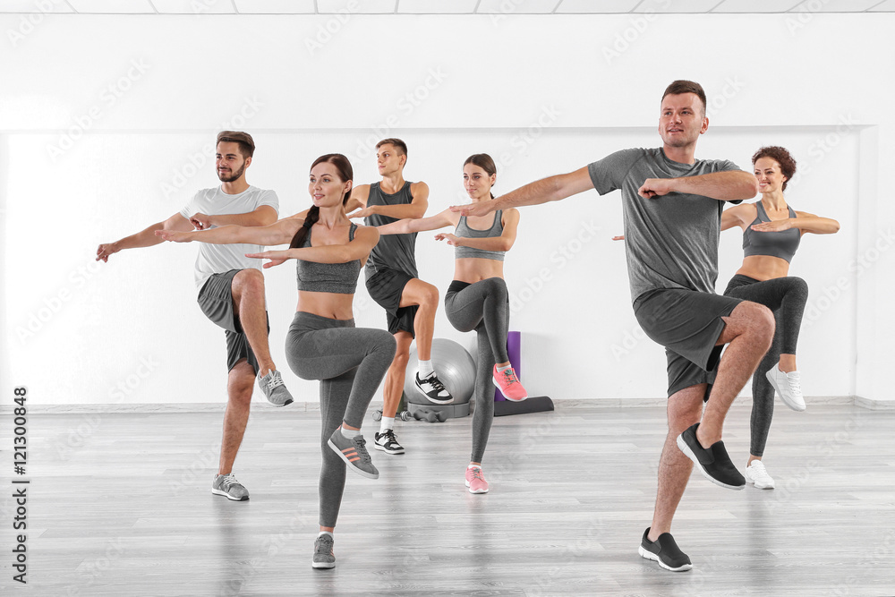 Group of people doing exercises in gym Stock Photo | Adobe Stock