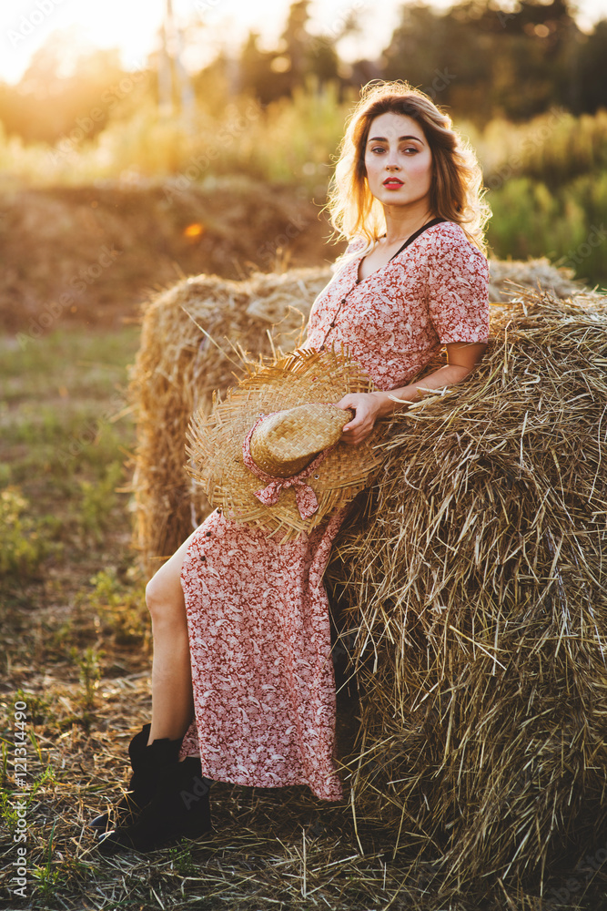 Beautiful woman on a haystack Stock-Foto | Adobe Stock