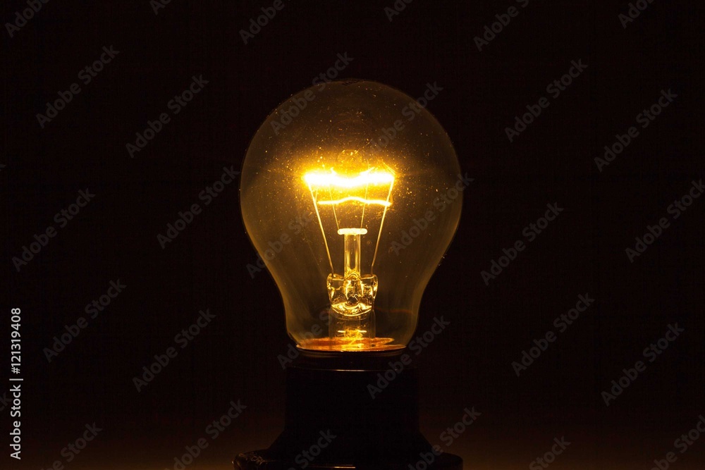 Glowing glass light bulb on dark background Stock Photo | Adobe Stock