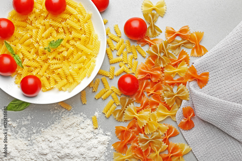 Plate with different kinds of pasta with cherry tomatoes on table Stock ...