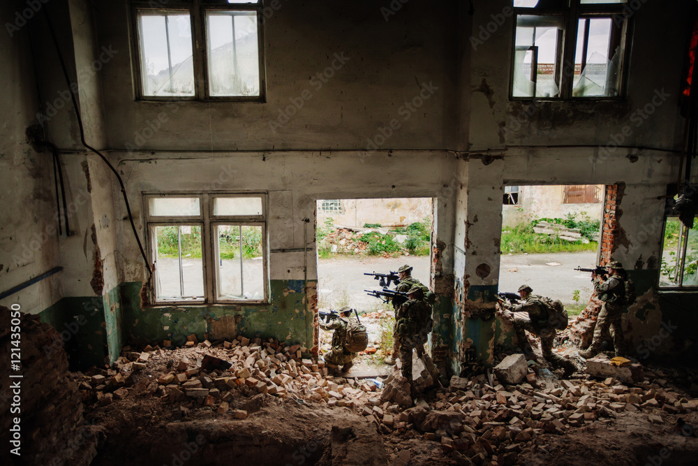 Foto de Soldiers on patrol in destroyed city. Military and rescue ...