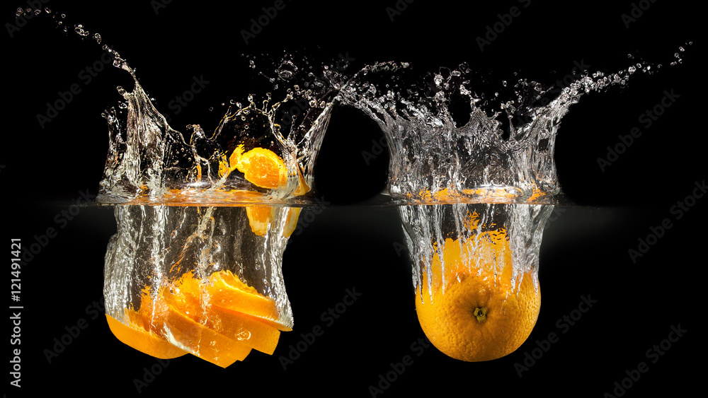 Group of fresh fruits falling in water with splash on black background ...