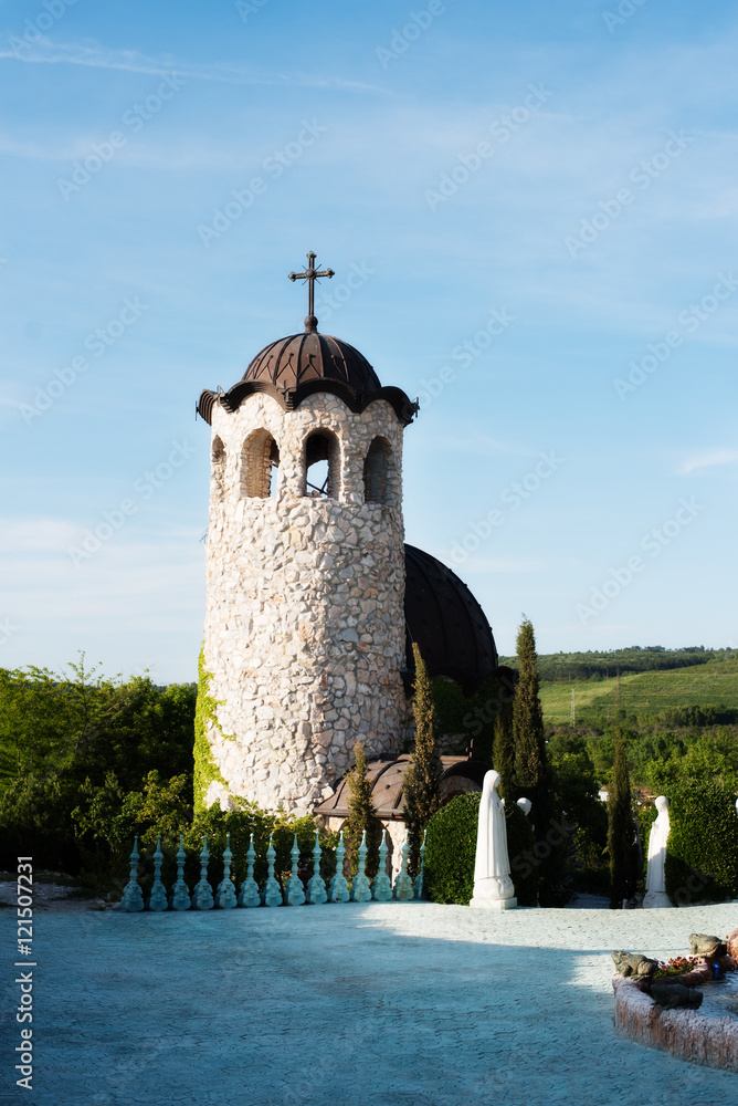 Old stone chapel in the garden of fabulous ancient castle. Alley in ...