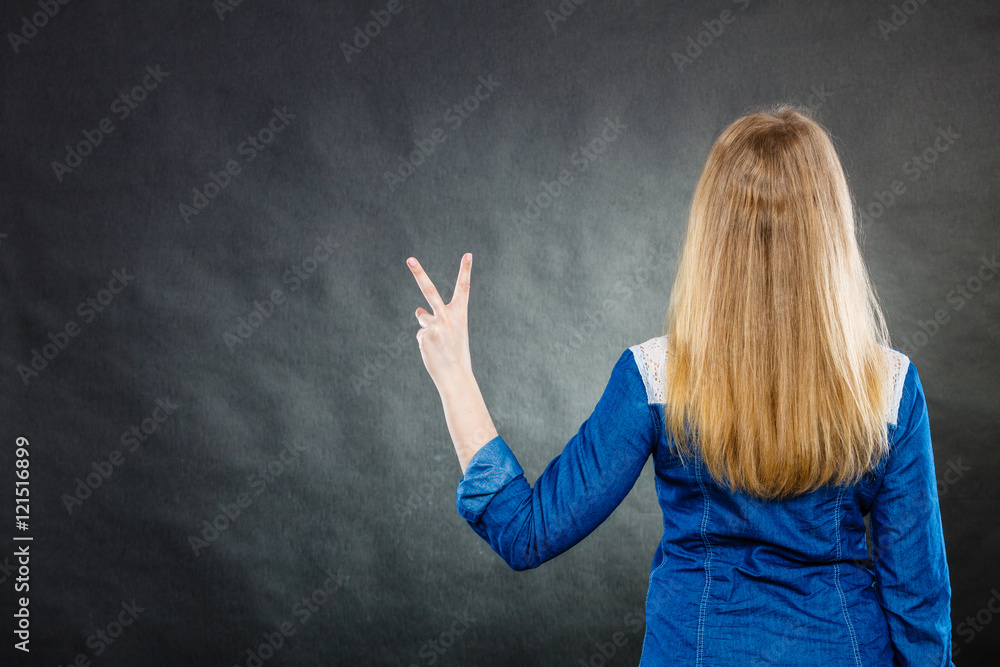 Back view of blonde woman with thumb up. Stock Photo | Adobe Stock
