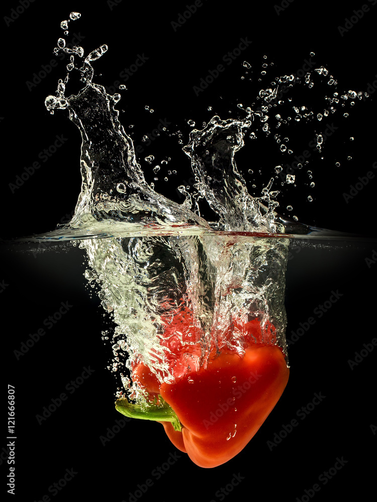 Red bell pepper falling in water with splash on black background Stock ...