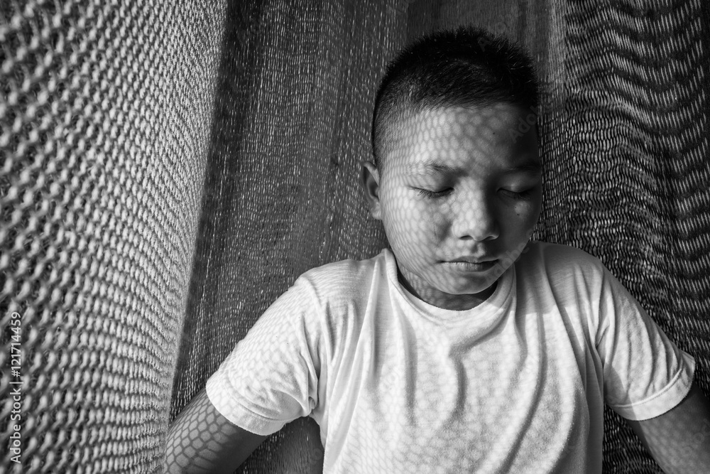 scared and alone, young Asian child who is at high risk of being ...