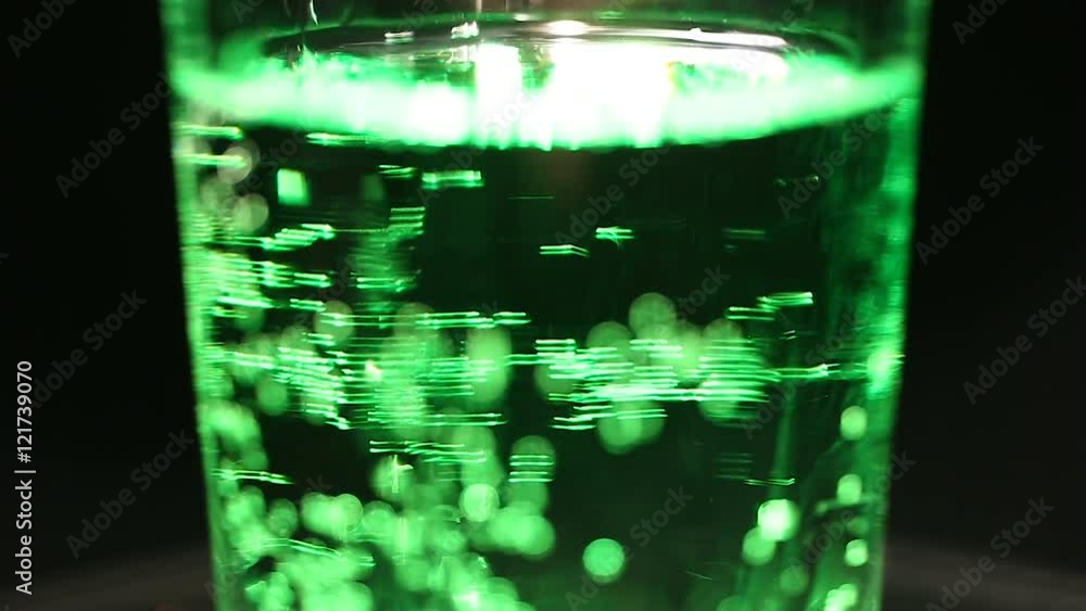 Poisonous green liquid substance sparkling in glass, toxic drink, life ...