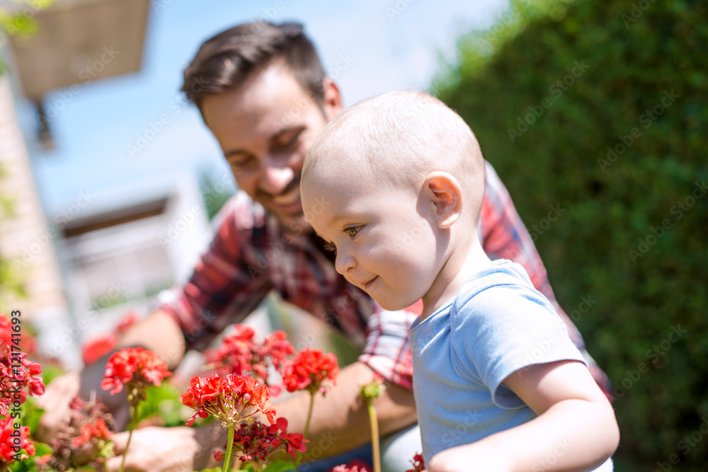 Father and son working together in the garden.Little boy helping his ...