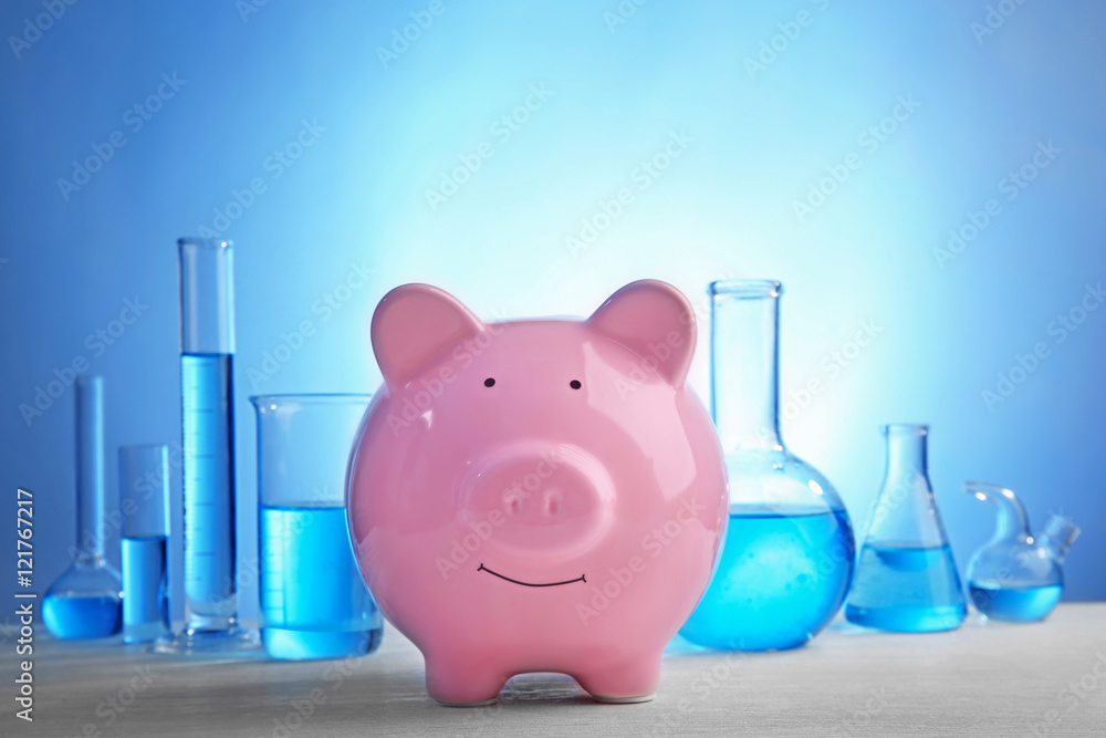 Pig money box and water in tubes on table. Saving water concept Stock ...