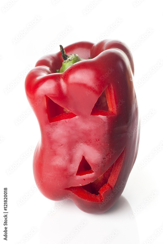 Food art creative concept. Halloween scary face carved into red ...