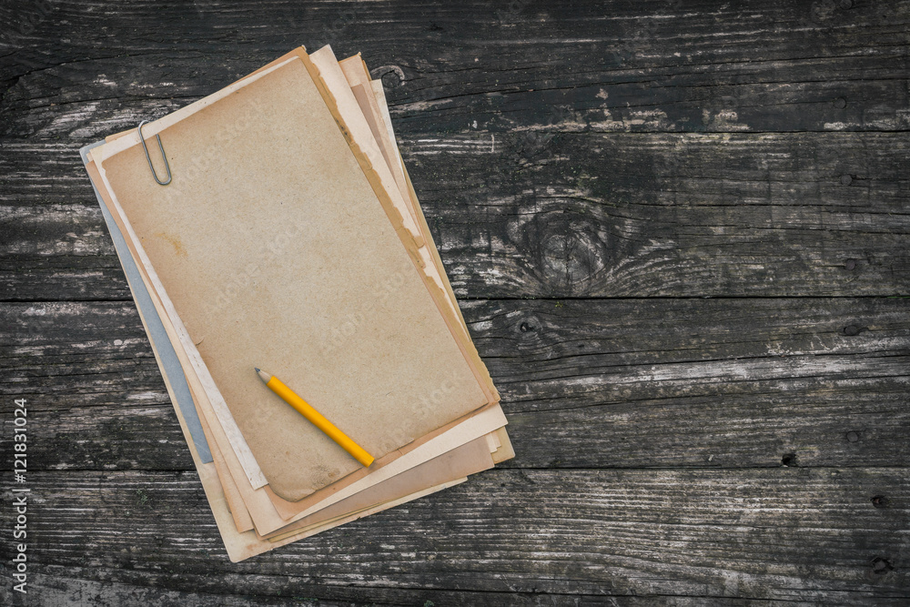 Stack of old paper and pencil Stock Photo | Adobe Stock