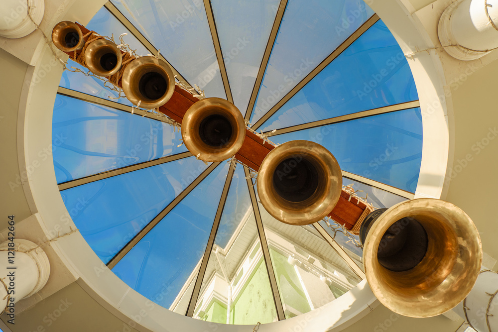 Under the bells. Abstract view from below of a number of church bells ...