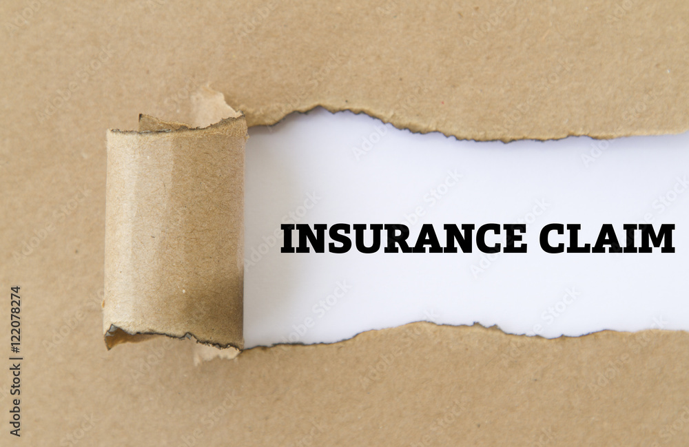 INSURANCE CLAIM written under torn paper. Stock Photo | Adobe Stock
