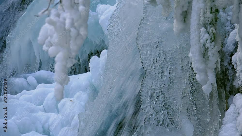 Wonderful waterfall in winter time with traces of ice melting in pure ...