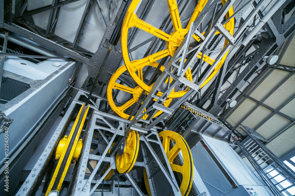 Gears of cable road mechanism pulling metal cable in control room ...