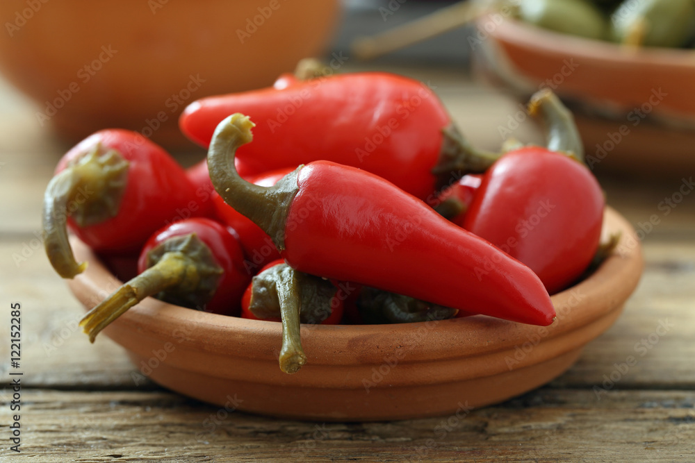 peperoncini piccanti in aceto sfondo rustico Stock Photo | Adobe Stock