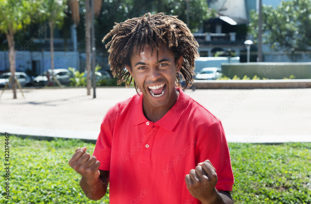 Cheering african american guy with amazing hairstyle Stock Photo ...