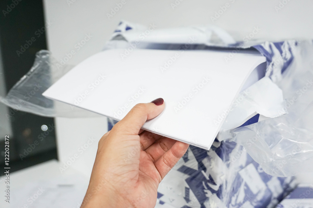 Pull paper from the ream to insert into printer Stock Photo | Adobe Stock