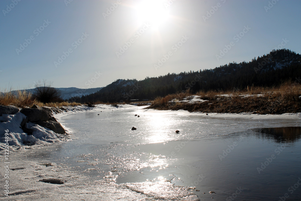 Melting Frozen Stream/Sun shining down and reflecting on thawing stream ...