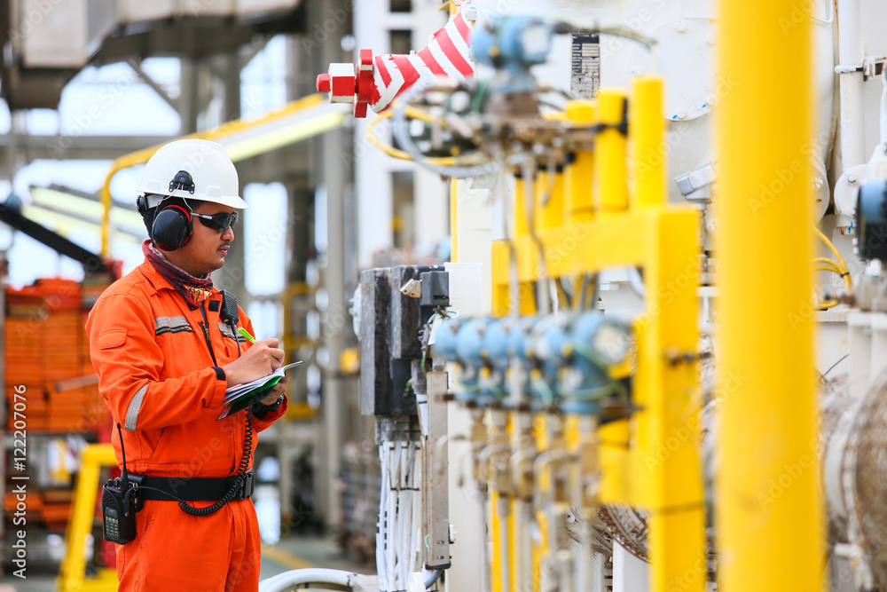 operator recording operation of oil and gas process at oil and rig ...