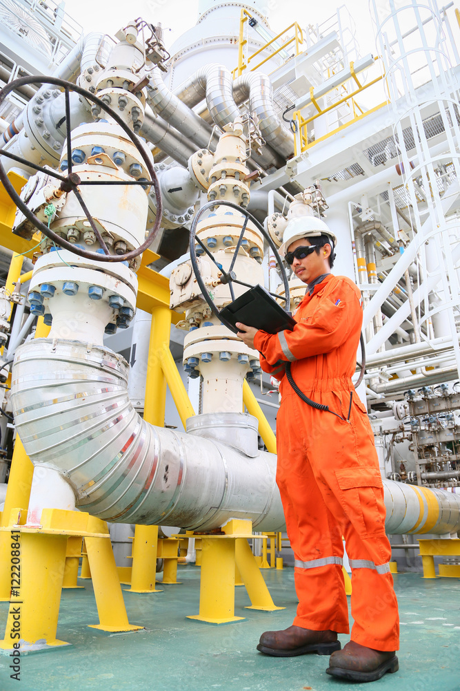 operator recording operation of oil and gas process at oil and rig ...