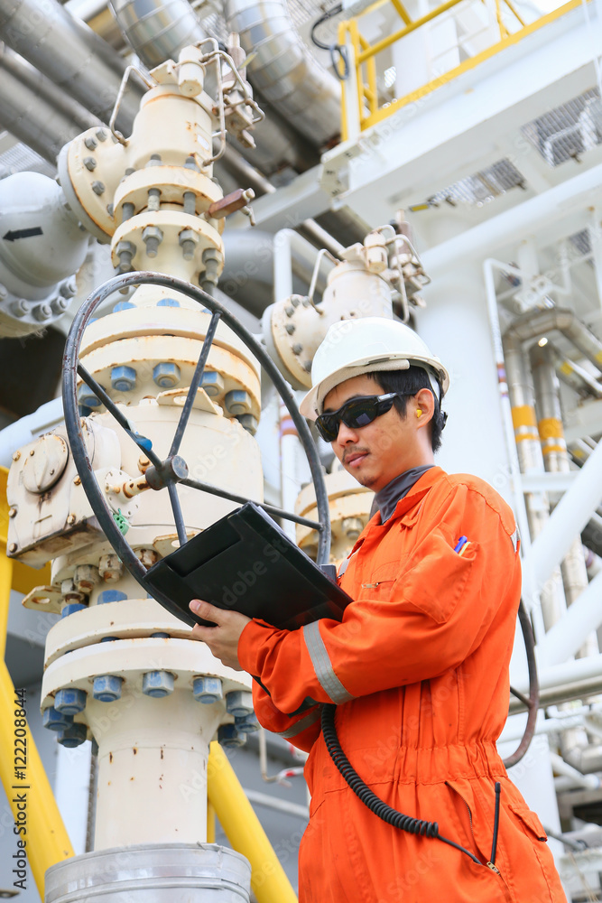 operator recording operation of oil and gas process at oil and rig ...