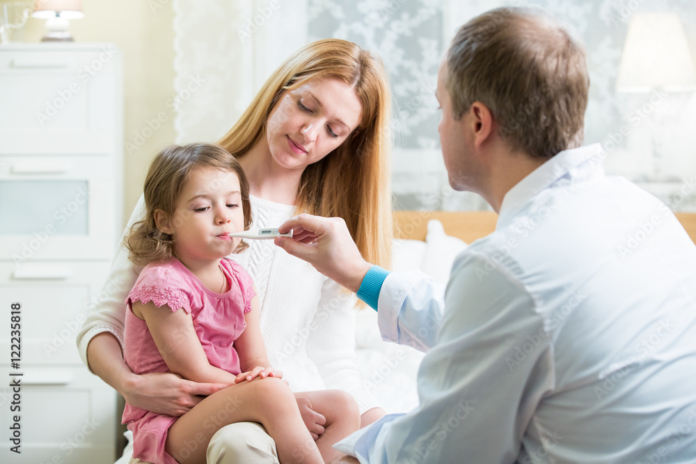 Male Pediatrician measuring temperature of little ill girl. Kid looks ...