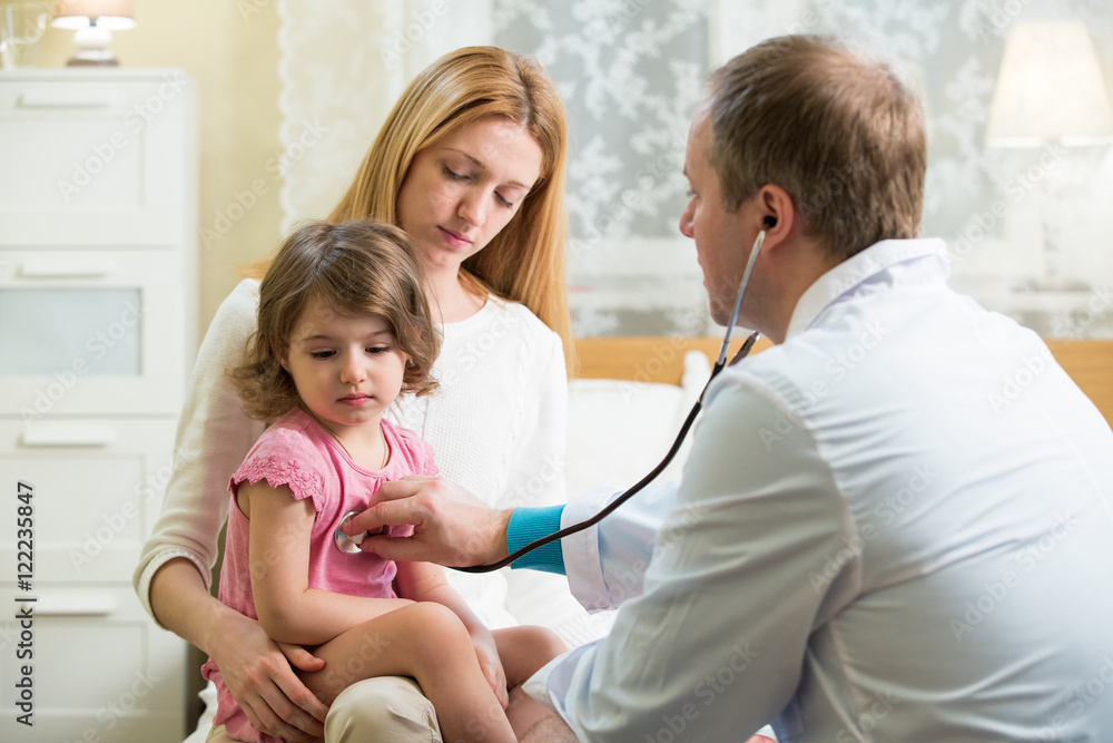 Male Pediatrician examining cute little girl with stethoscope. Kid ...