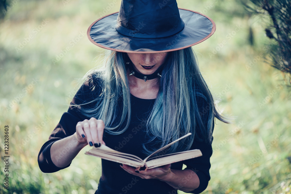 Witch reading a book Stock-Foto | Adobe Stock