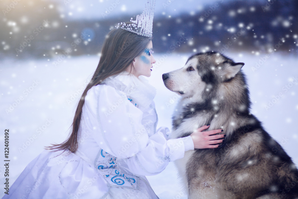Snow queen in winter. Fairy tale girl with Huskies or Malamute ...