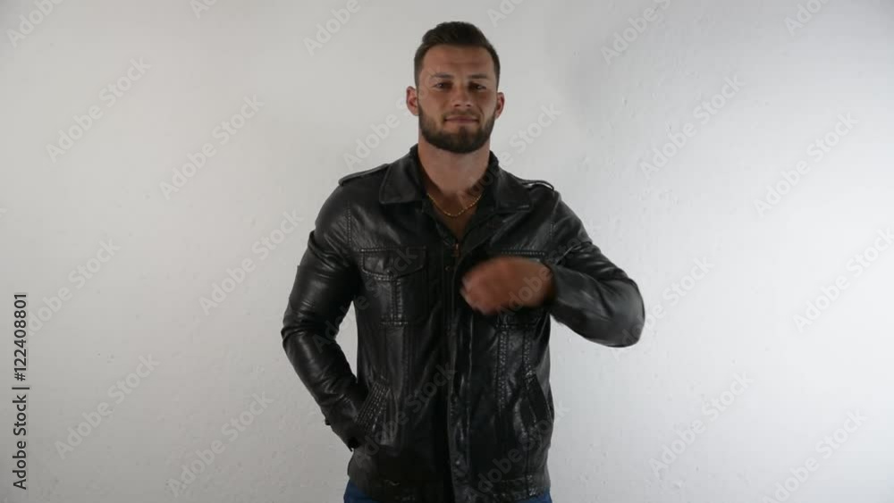 Bodybuilder handsome man undressing, taking off jacket against white ...