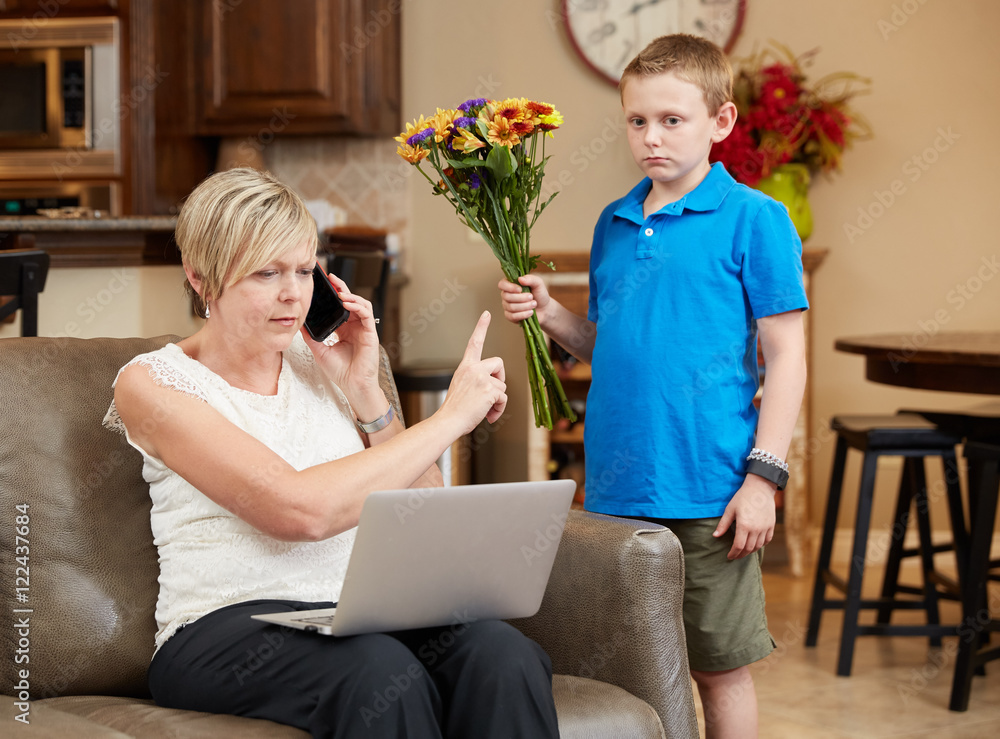 Busy Mom Ignoring Son with Flowers Stock Photo | Adobe Stock