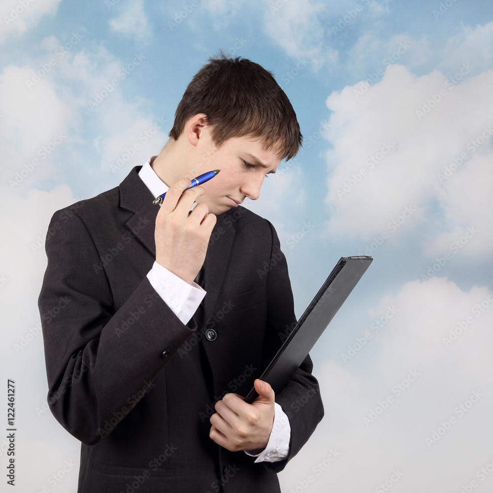 Young manager - Teenage boy in business suit with pen and folder in ...