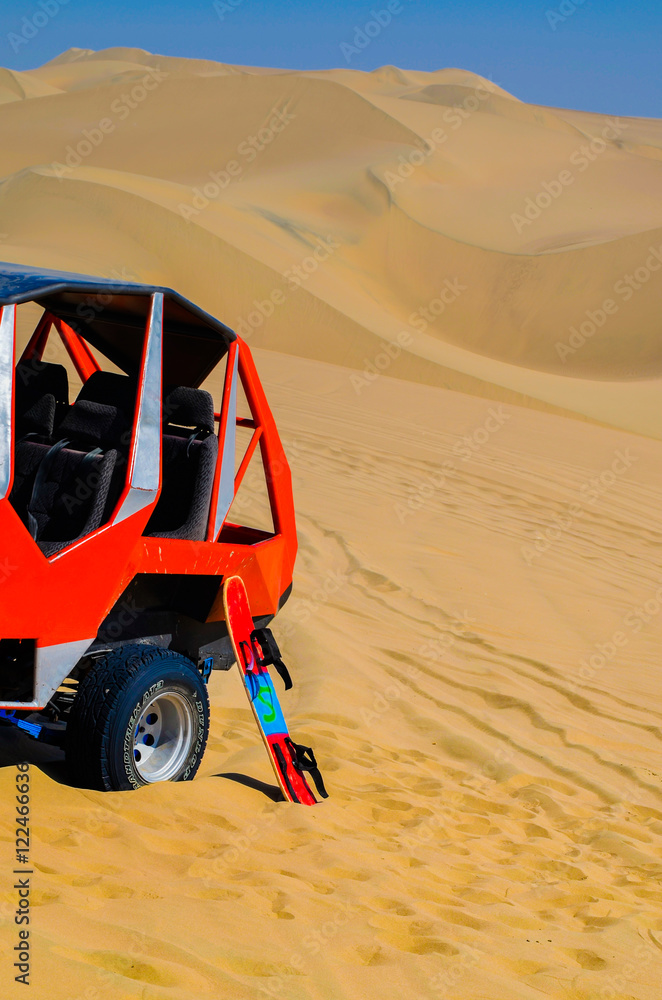 Dune buggy used to carry tourists practicing sand-boarding on the dunes ...
