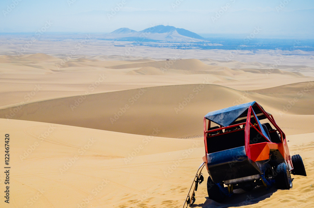 Dune buggy used to carry tourists practicing sand-boarding on the dunes ...