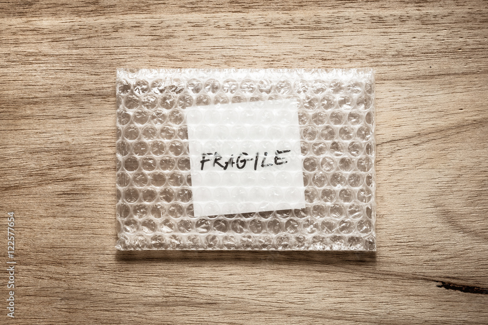 fragile, handwriting on white squre paper in bubble pack, rought wood ...
