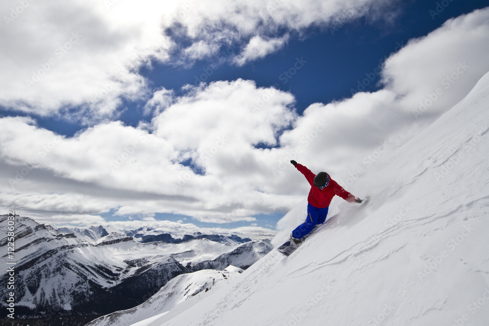 Young man snowboarding at Lake Louise Resort, Banff National Park ...