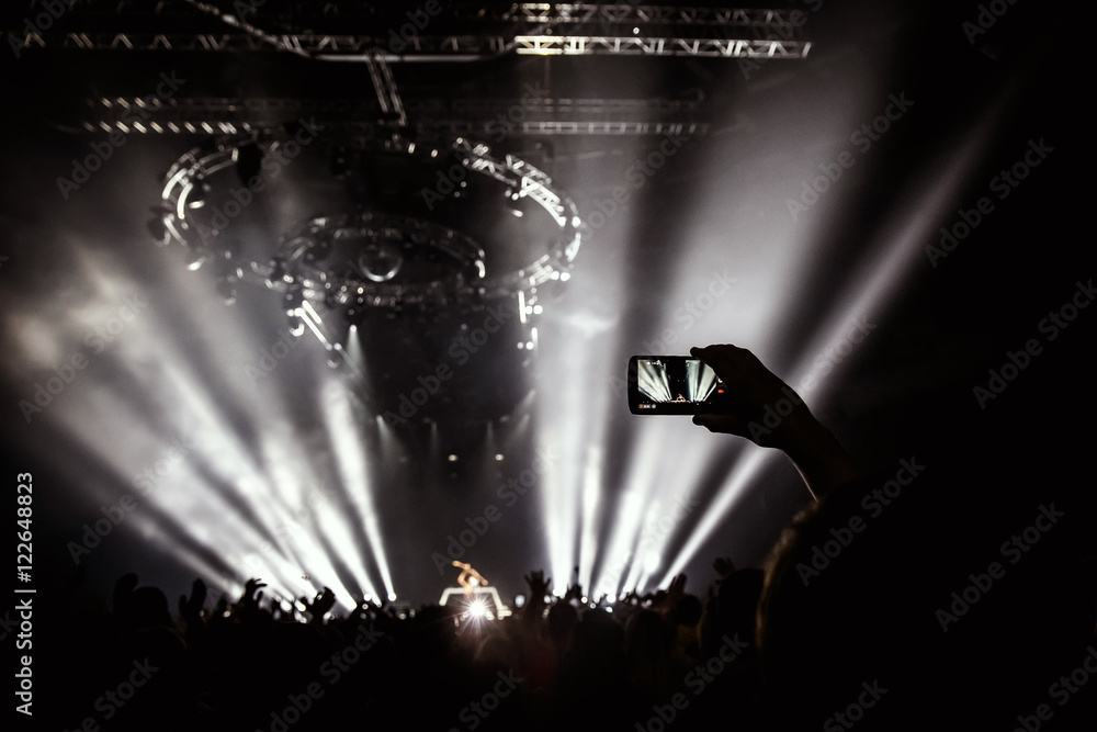 Hand with a smartphone records live music festival, Taking photo of ...