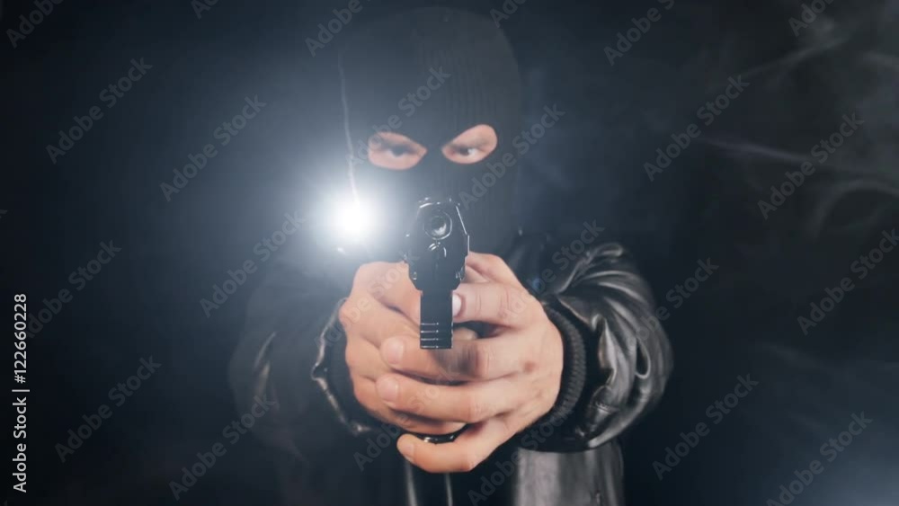gangster appears in the dark pointing pistol gun to the camera Stock ...