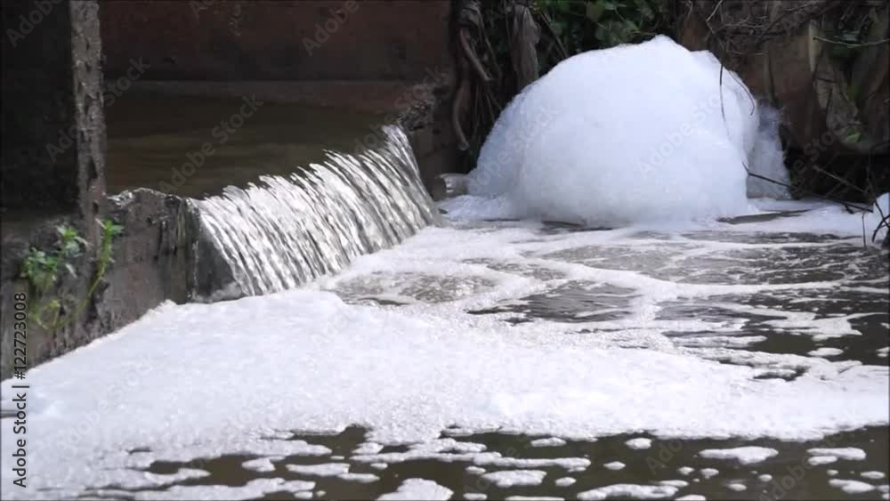 Water pollution - Waste water full of bubbles released from the ...