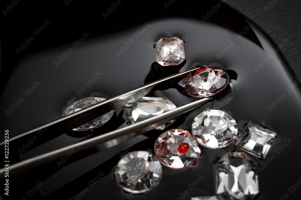 Blood diamond concept image with diamonds submerged in blood and a pair ...
