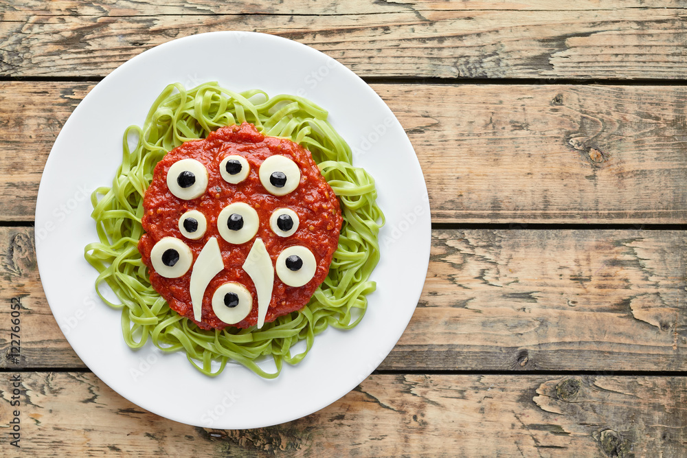 Scary halloween monster green spaghetti pasta with fake blood tomato ...